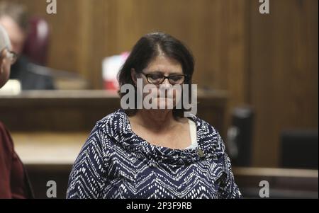 Jodi Routh, mother of Eddie Ray Routh, looks down after answering a ...