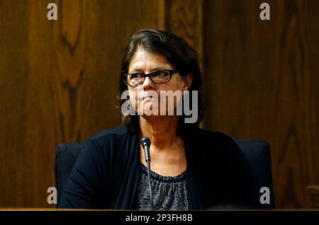 Jodi Routh, mother of Eddie Ray Routh, looks down after answering a ...