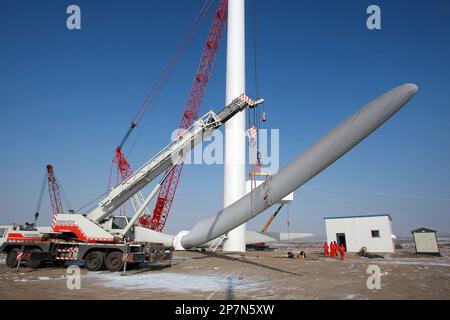 Workers of the Xinjiang Goldwind Science and Technology Co. Ltd ...