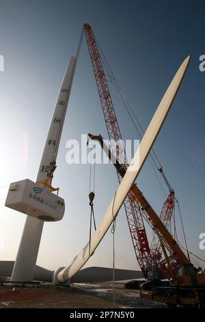 Workers of the Xinjiang Goldwind Science and Technology Co. Ltd ...