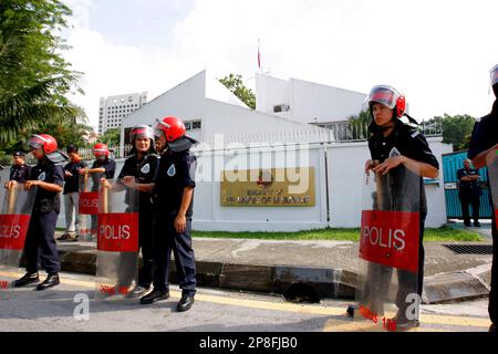 Riot police guard the Malaysian Embassy at the financial district of ...