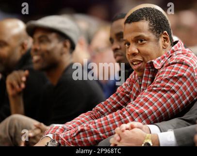 Sean "Diddy" Combs, left, sits beside Cassie as they watch a giant ...