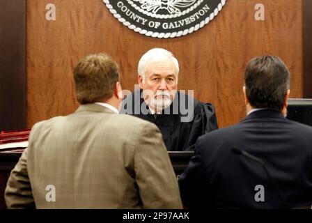 Judge David Garner, center, speaks with defense attorney Tom Stickler ...