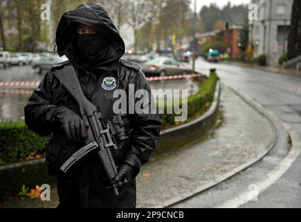 A Basque police officer controls the perimeter of the cemetery as a ...