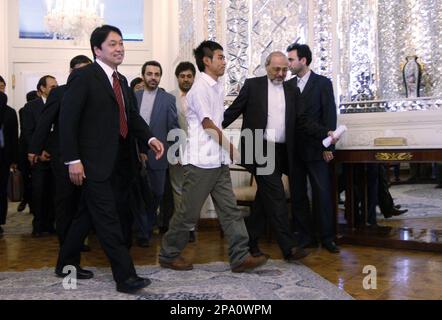 Iranian Deputy Foreign Minister Alireza Sheikh-Attar, right, shakes ...