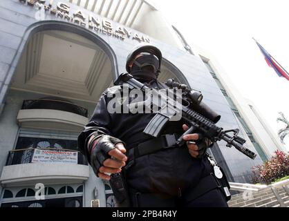 A SWAT member of the Philippine National Police fires at his target as ...