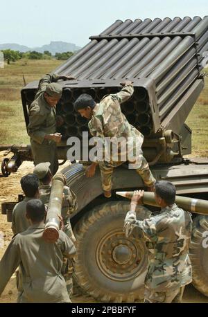 Sri Lankan troops load rockets into a multi barrel rocket launcher to ...