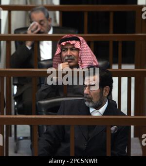 Saddam Hussein, foreground, along with co-defendant Sultan Hashim Ahmad ...