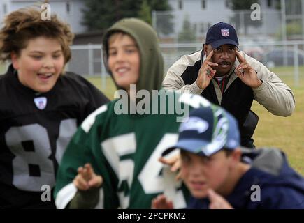 Retired Los Angeles Raiders running back Dokie Williams gives the ball ...