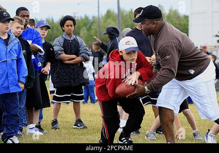 Retired Los Angeles Raiders running back Dokie Williams gives the ball ...