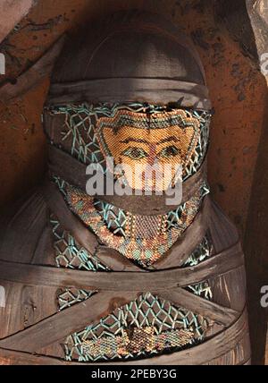 The face of an ancient wooden coffin, shaped like a human body that ...