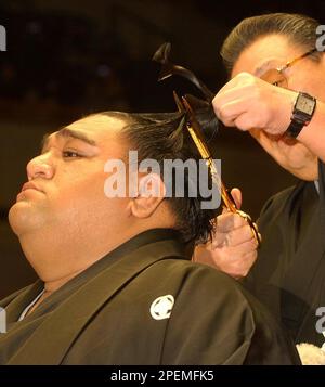 Former grand champion Musashimaru sheds a tear just after his top knot ...