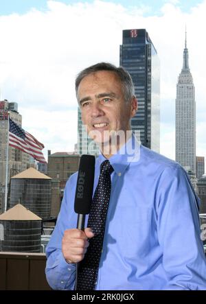 Associated Press President and CEO Tom Curley, background, delivers a ...