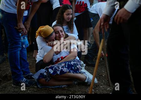 Mourners gather around the graves of British-Israelis Lianne Sharabi ...