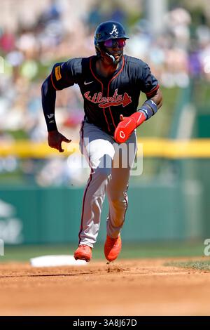 Atlanta Braves' Matt Olson, left, is congratulated by first base coach ...