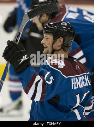 Colorado Avalanche center Matt Hendricks, front, rolls the puck in for ...