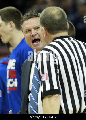 Kansas head coach Bill Self, left, has words with referee Gerry Pollard ...