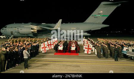 Afghan honor guards carry the coffins of Afghanistan’s first president ...