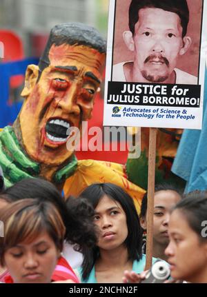 Protesters display placards as they gather at Mendiola Bridge leading ...