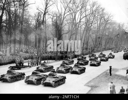 German Chancellor Adolf Hitler passes a saluting tank detachment lined ...
