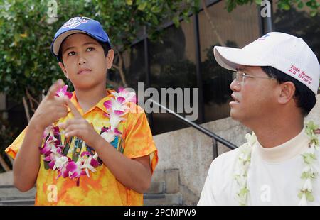 Deaf baseball player Justin "Pono" Tokioka, 11, watches his interpreter ...