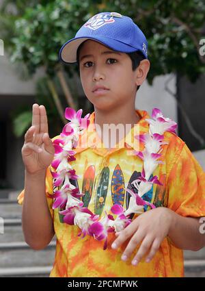 Deaf baseball player Justin "Pono" Tokioka, 11, watches his interpreter ...