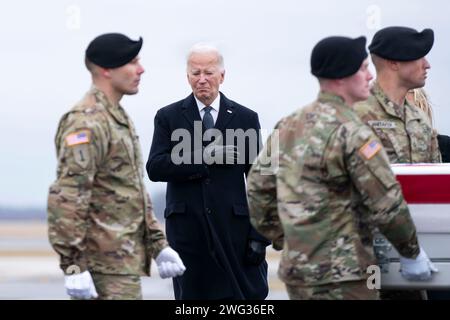 President Joe Biden watches as a carry team moves a transfer case ...