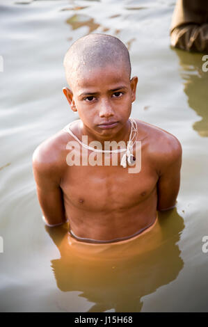 An Indian Sadhu boy, Hindu holy child smiles on the banks of River ...